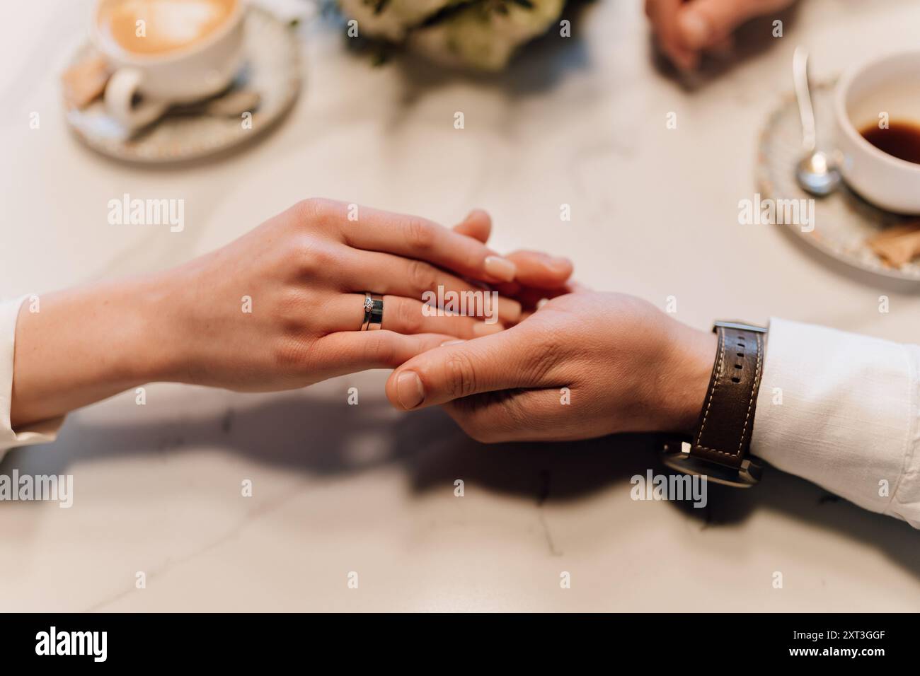 Romantic engagement moment, couple holding hands with rings ...