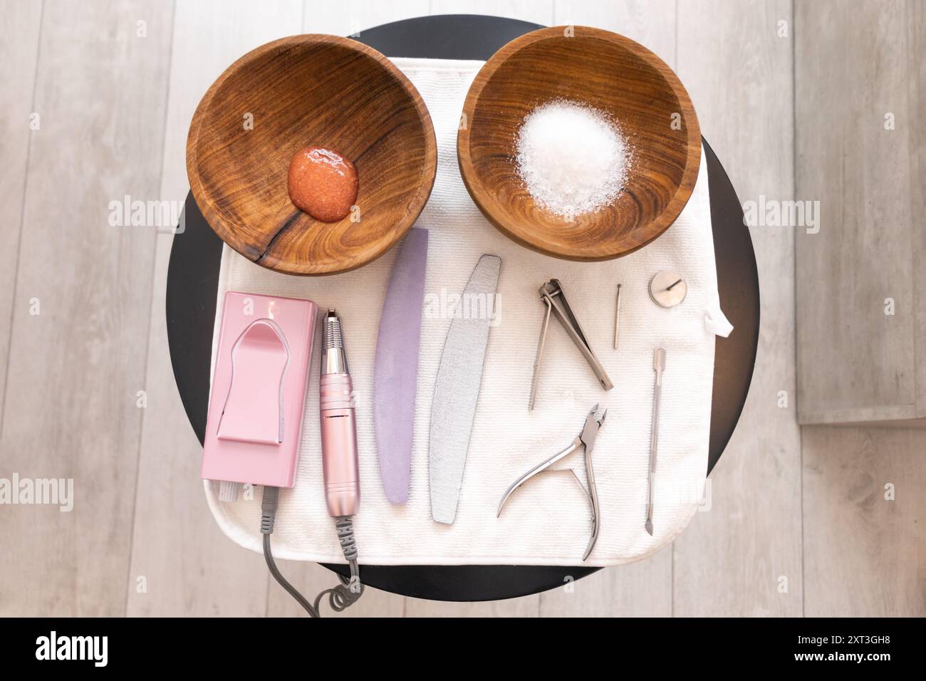 An orderly arrangement of pedicure tools on a table, including bowls ...