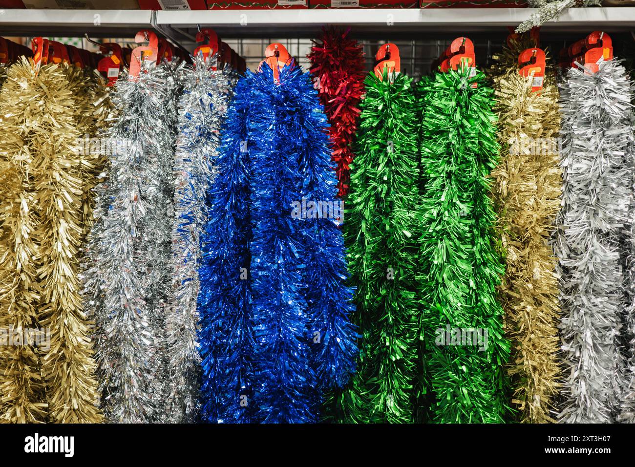 Rows of colorful Christmas tinsel, available in gold, silver, blue, red ...