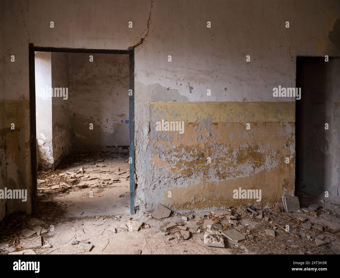 An eerie interior view of an abandoned building with crumbling walls ...