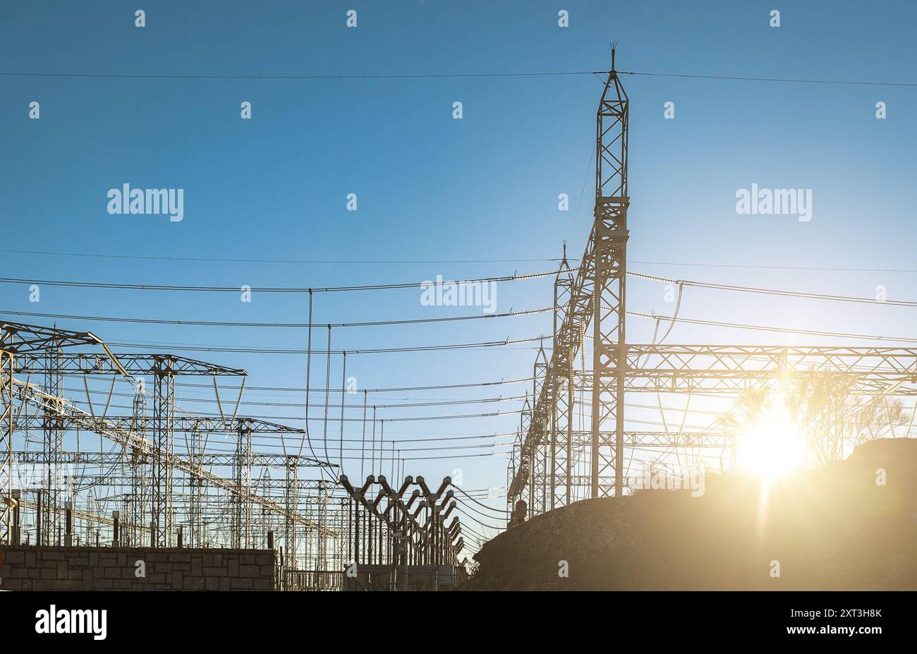 Sunset silhouette of a hydroelectric power plant's infrastructure in ...