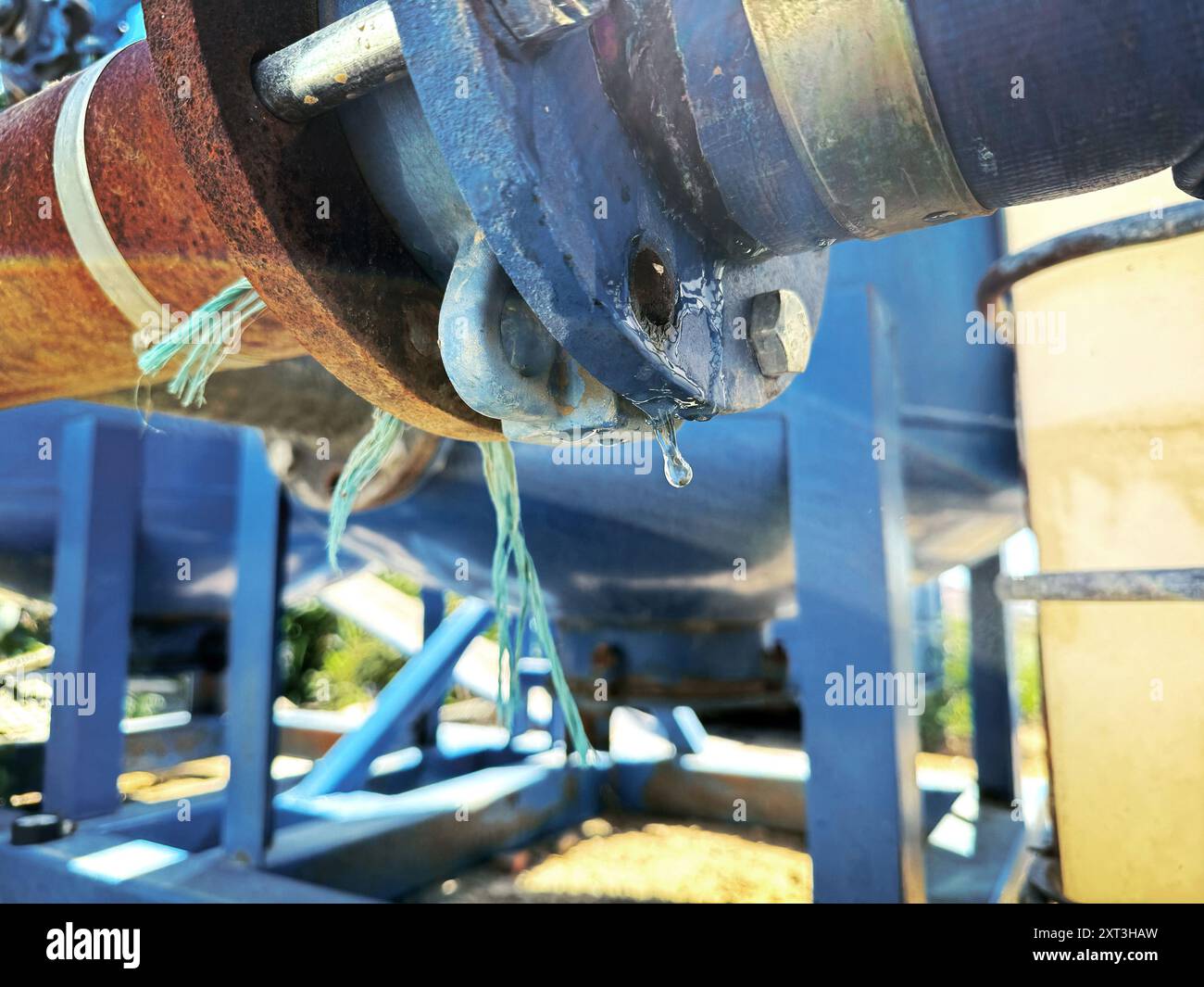 Close-up image showcasing a water droplet forming at the joint of a ...