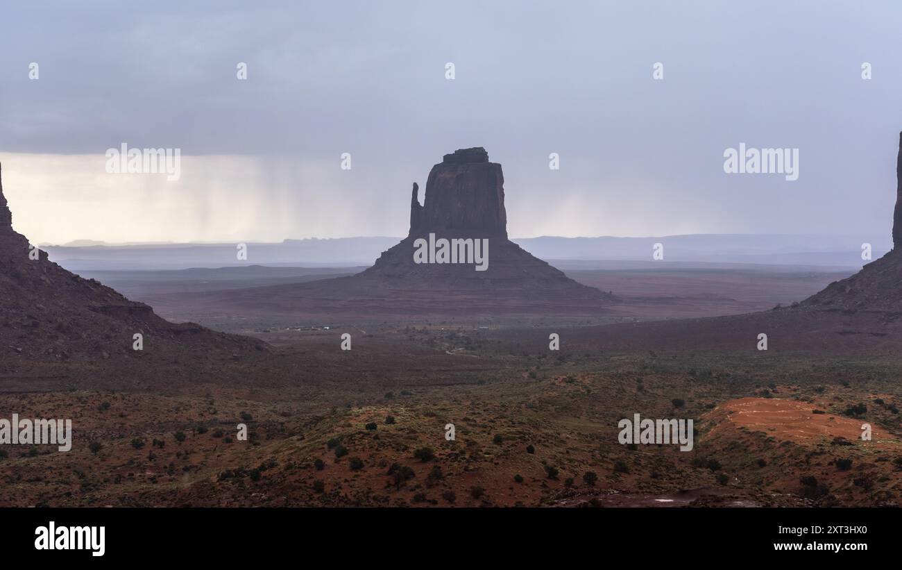 A dramatic view of a rainstorm descending over the iconic buttes of ...