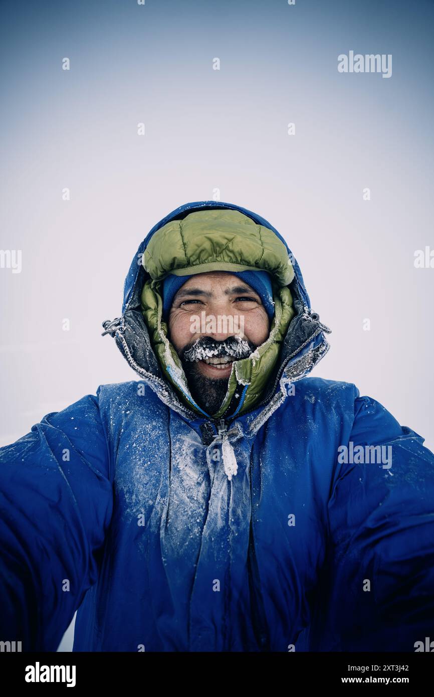 Self portrait of a man smiles warmly at the camera, his face partially ...