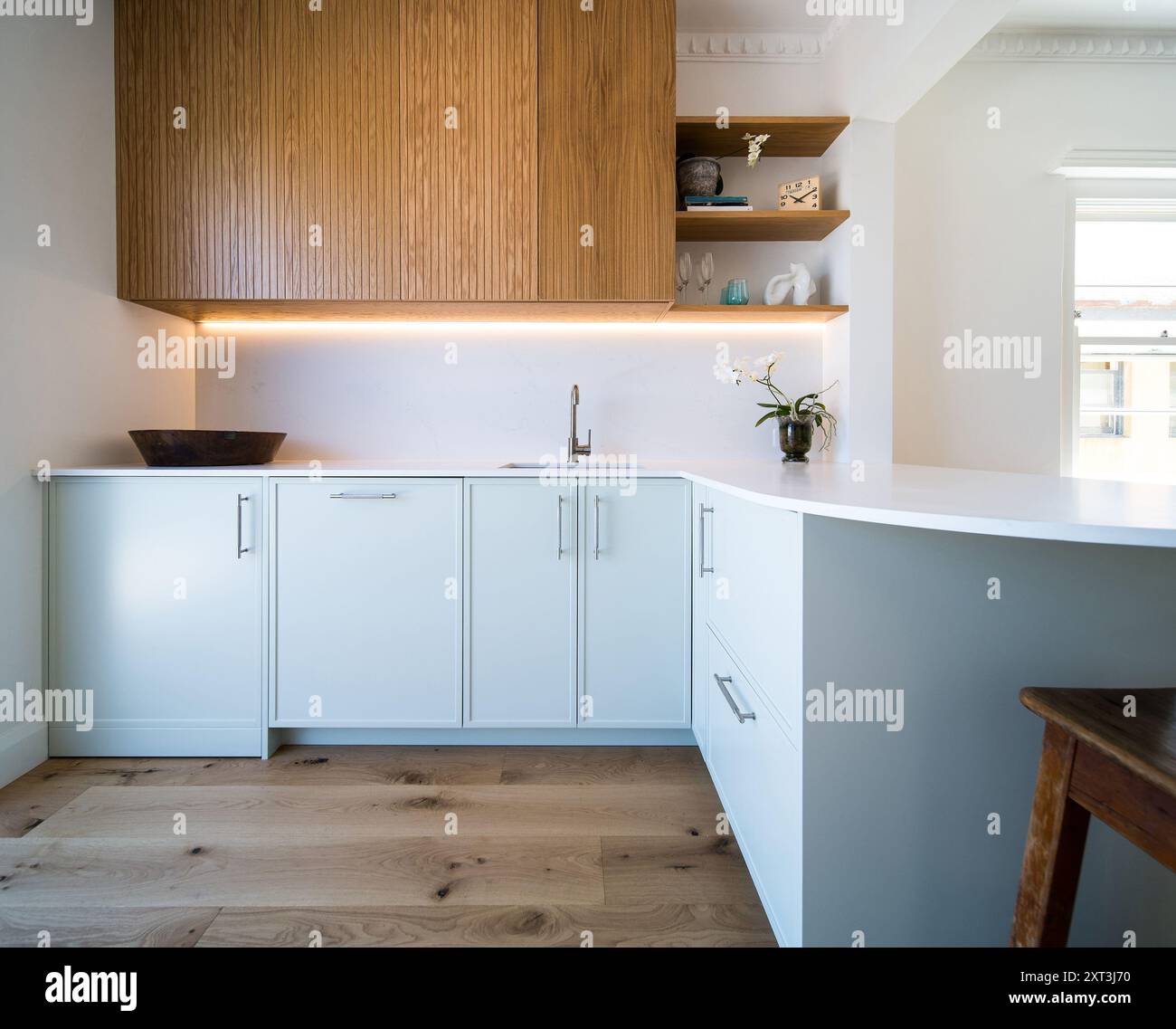 A serene modern kitchen interior showcases a combination of clean white ...