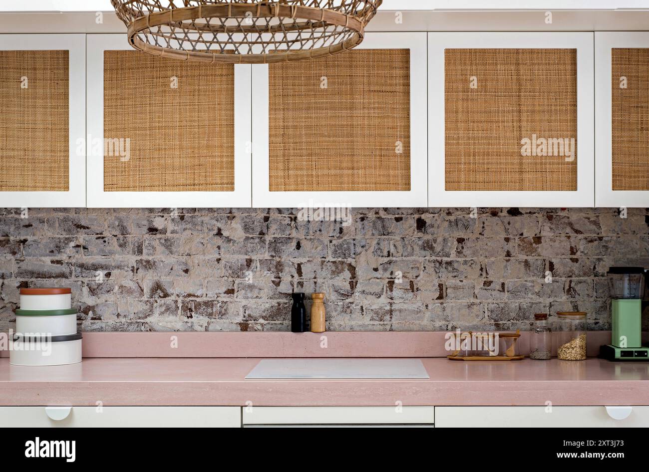 A contemporary kitchen showcases a unique blend of materials with pink ...