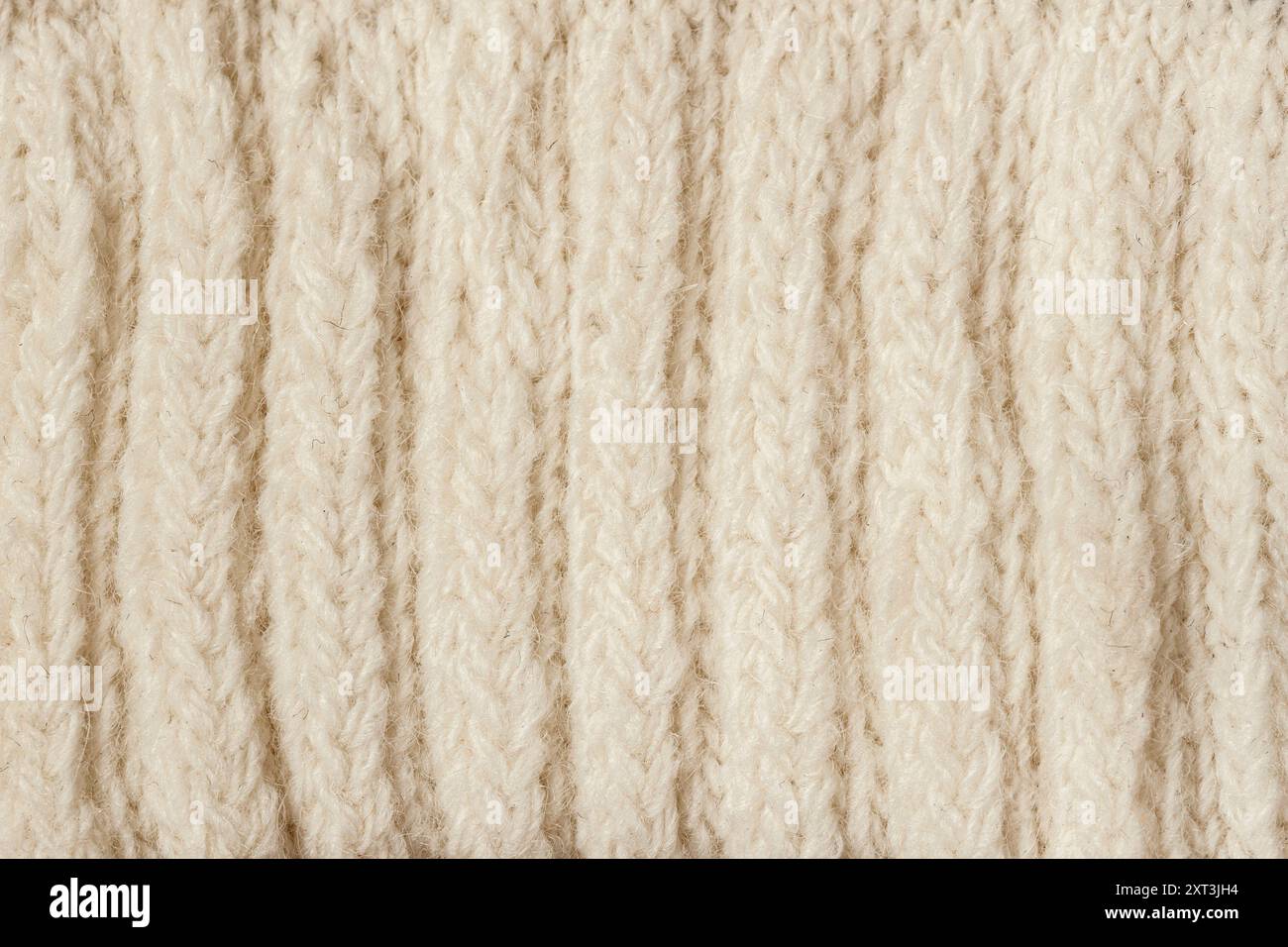 Cream colored craft knitted fabric featuring vertical ribbed patterns ...