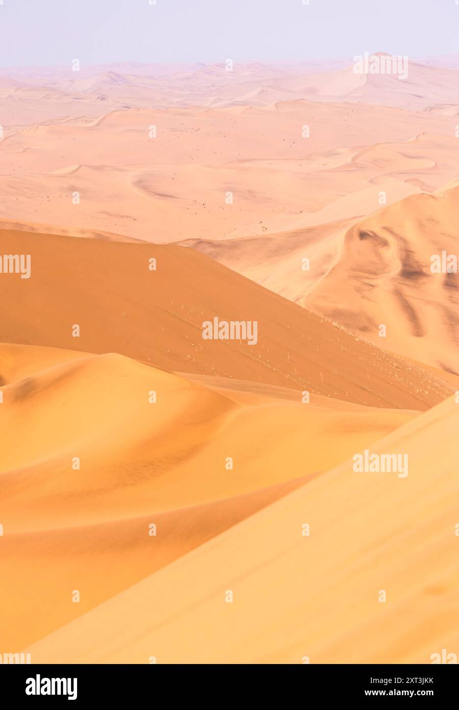 Rippling sand dunes under clear skies in the Namib Desert, Namibia ...