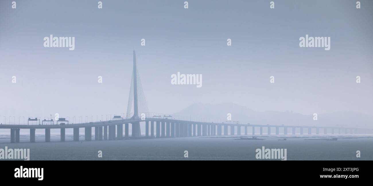A serene morning view of a sleek modern bridge shrouded in mist ...