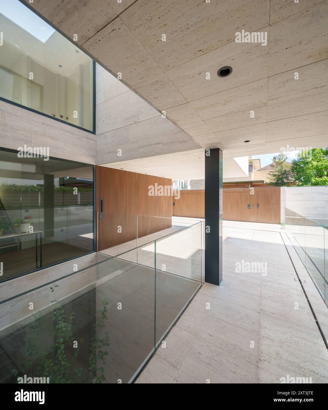 Contemporary house showcasing a fusion of glass panels and wooden ...