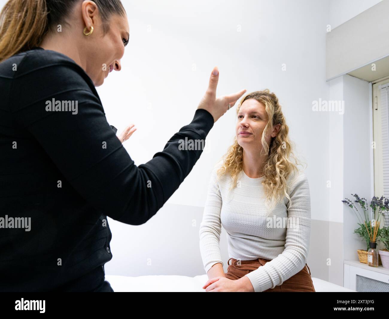 This image captures a beautician explaining the microblading treatment ...