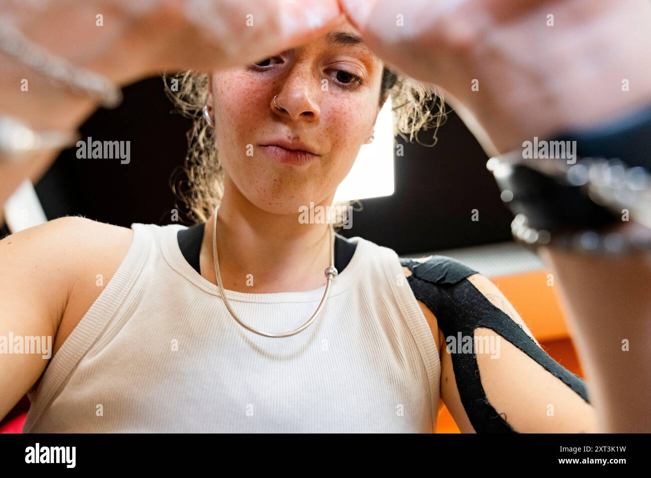 This close-up image captures a young woman intensely focused as she ...
