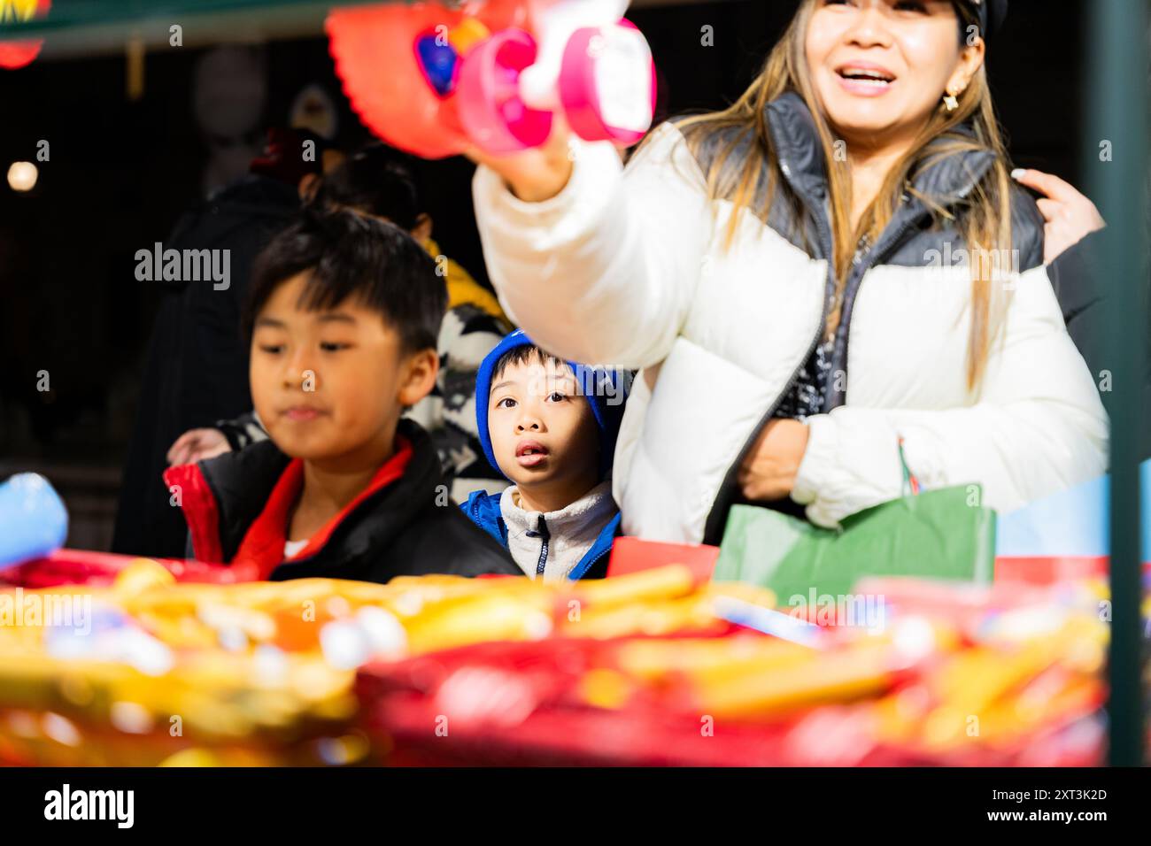 An Asian family with two boys excitedly exploring a stall at a ...