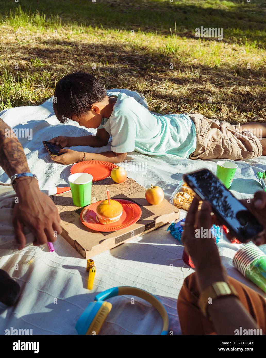 A harmonious scene of an Asian family spending quality time together during a sunny summer ...