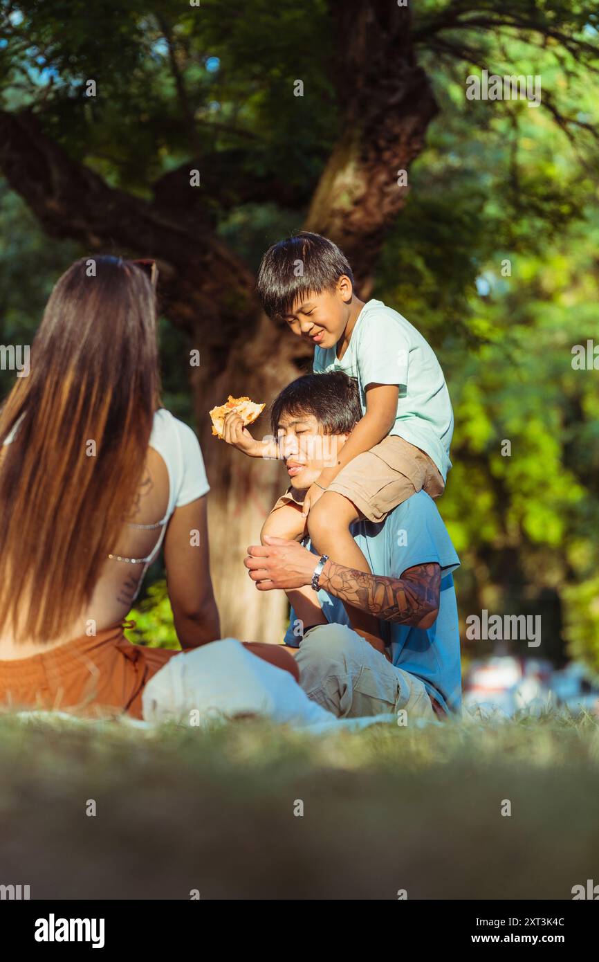 Kid sitting under shade tree hi-res stock photography and images - Alamy