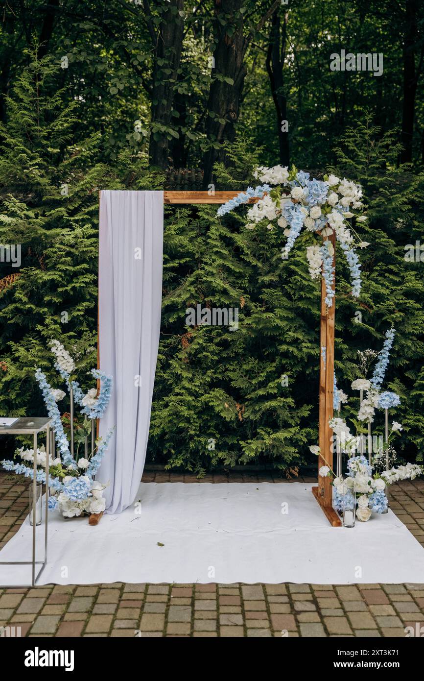 Elegant outdoor wedding arch with floral decorations for a romantic ...