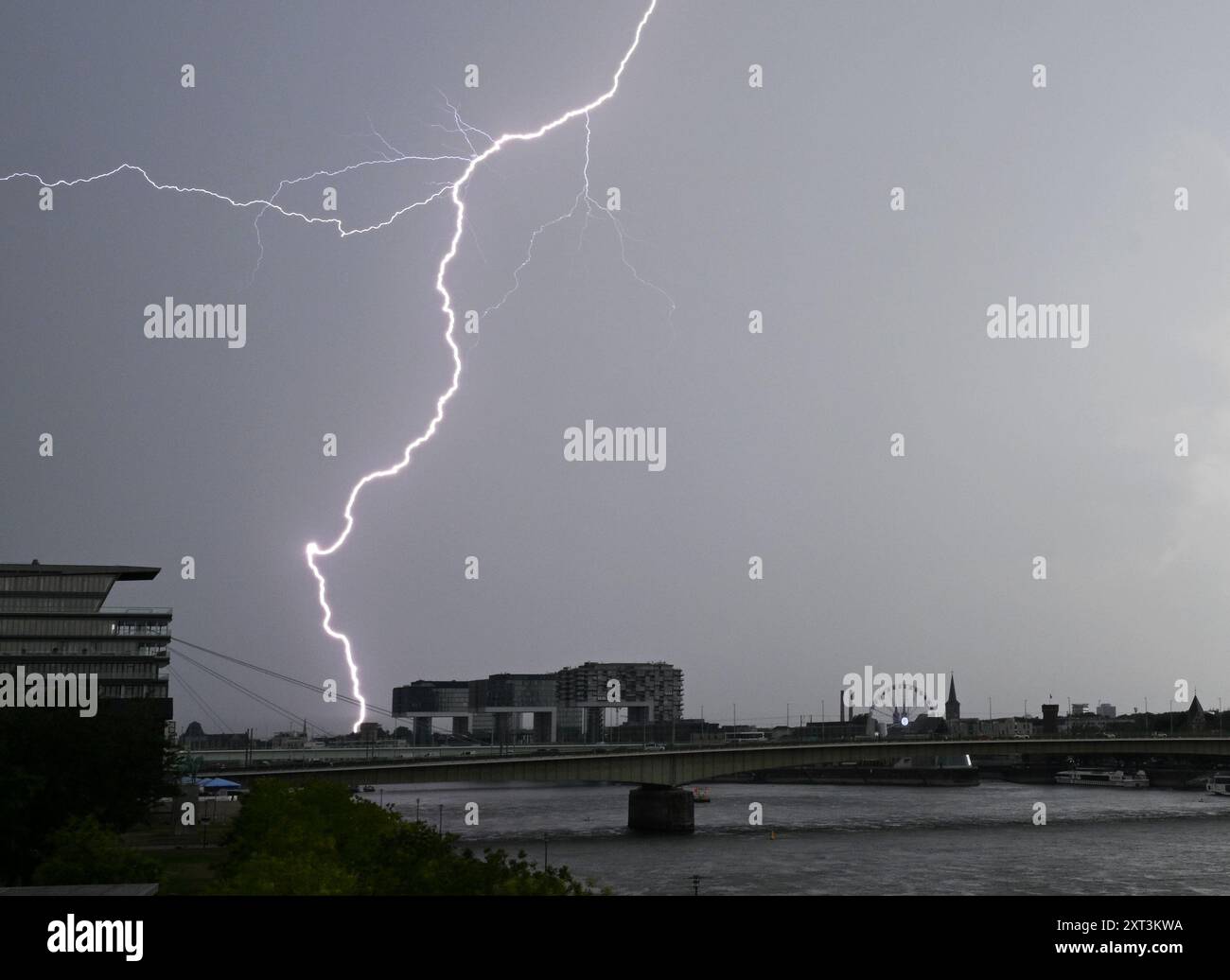 Cologne, Germany. 13th Aug, 2024. Lightning flashes across the sky over ...