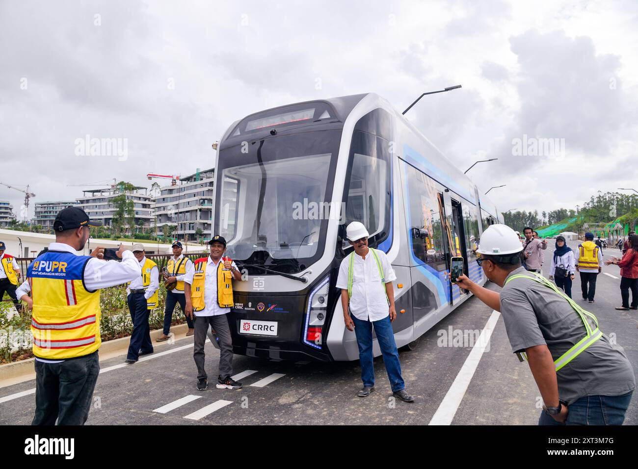 Nusantara, Indonesia. 13th Aug, 2024. People pose for photos with an Autonomous Rail Rapid ...