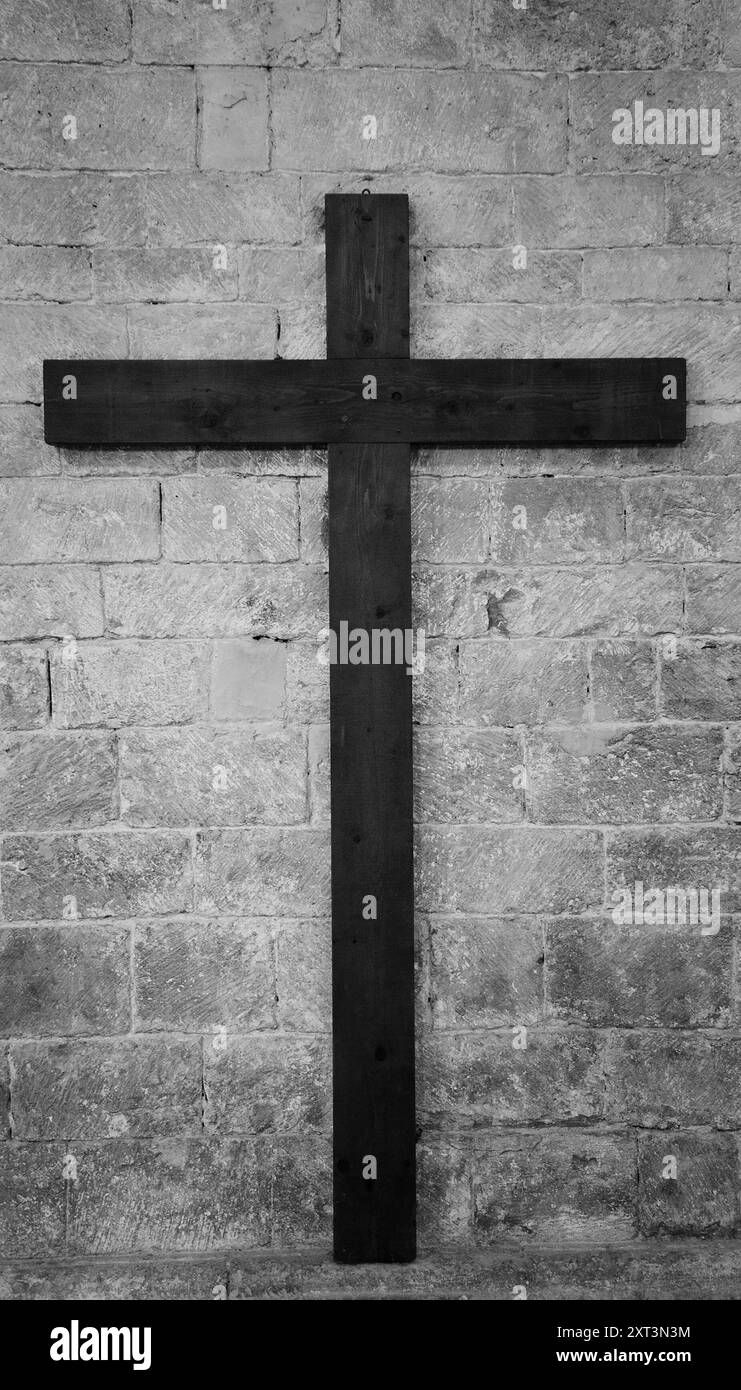 Antique wooden cross on stone brick wall of medieval church. Easter ...