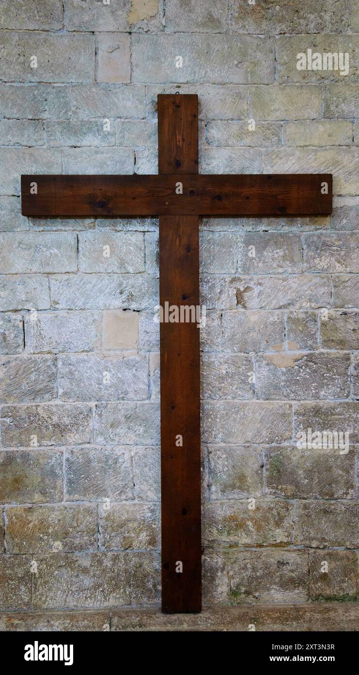 Antique wooden cross on stone brick wall of medieval church. Easter ...
