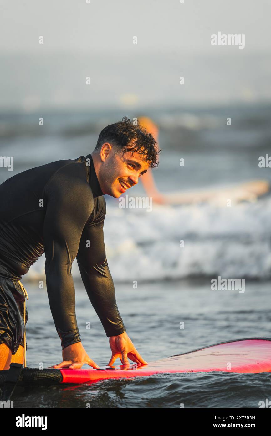 Happy young man after an afternoon surfing at the beach Stock Photo - Alamy
