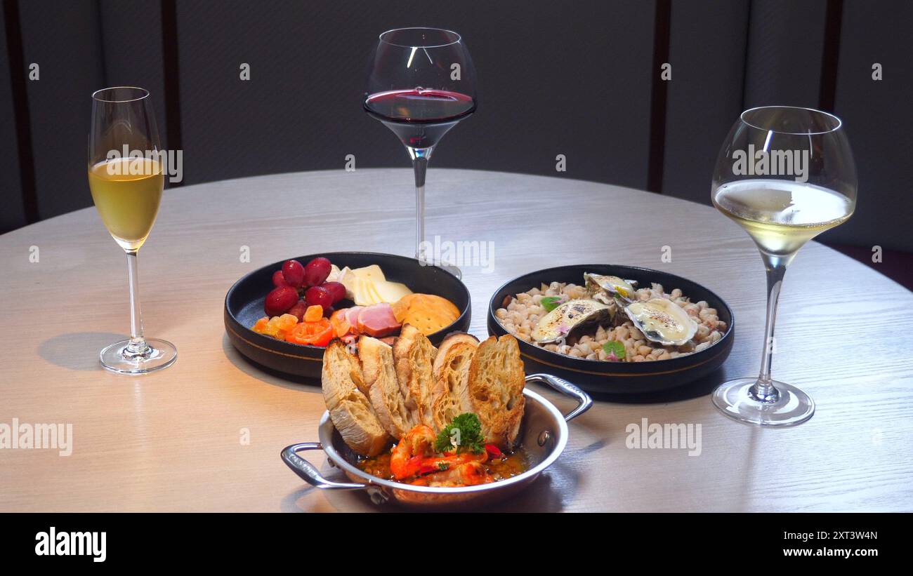 Elegant dining table set with gourmet dishes, assorted fruits, and Stock Photo - Alamy