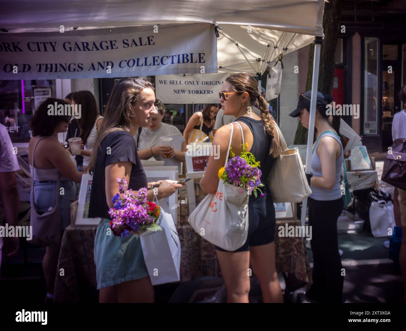 Shoppers brave the heat at a street fair on trendy Bleecker Street in ...