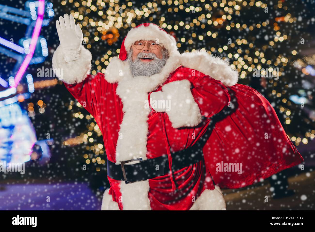 Portrait of positive cheerful grandfather santa carry presents bag arm ...
