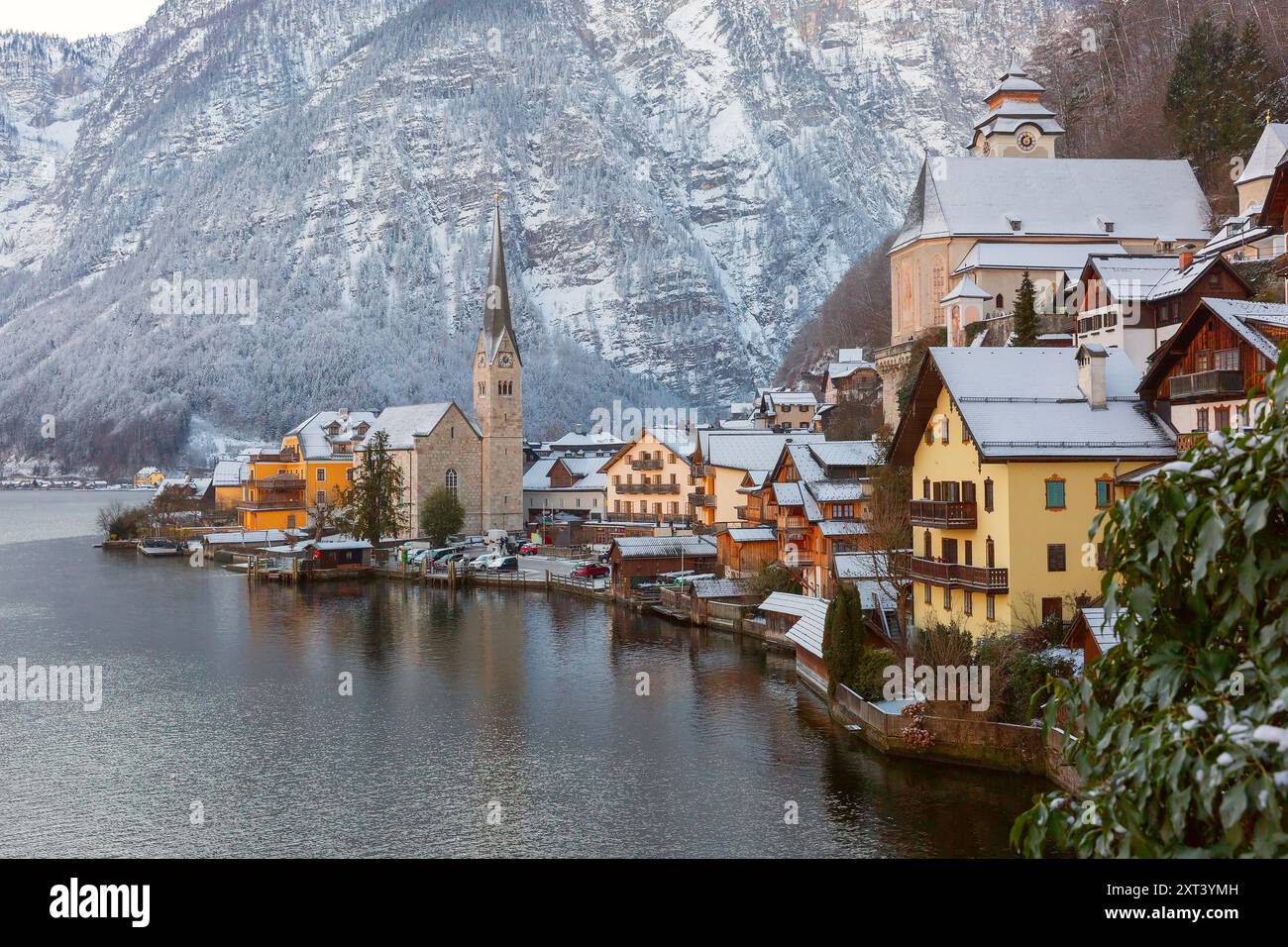 Winter Hallstatt village with snowy mountains and traditional houses ...