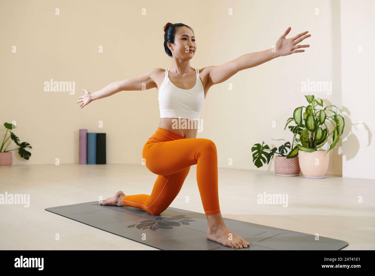 Practicing Yoga Poses in Bright Modern Indoor Setting Stock Photo - Alamy