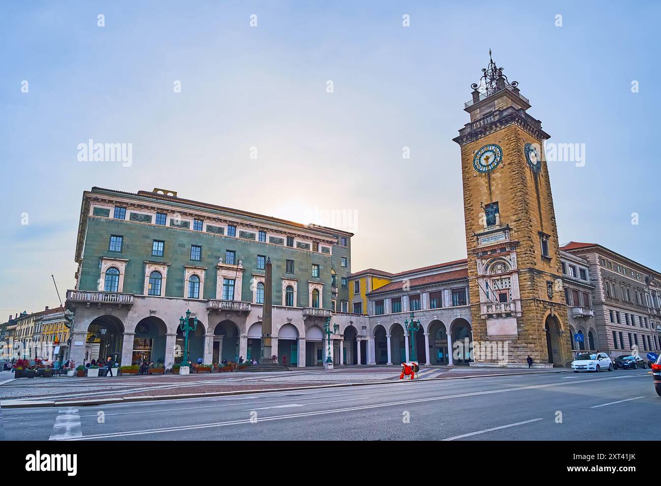 The sunset sky over the scenic architectural ensemble of historic Piazza Vittorio Veneto with ...