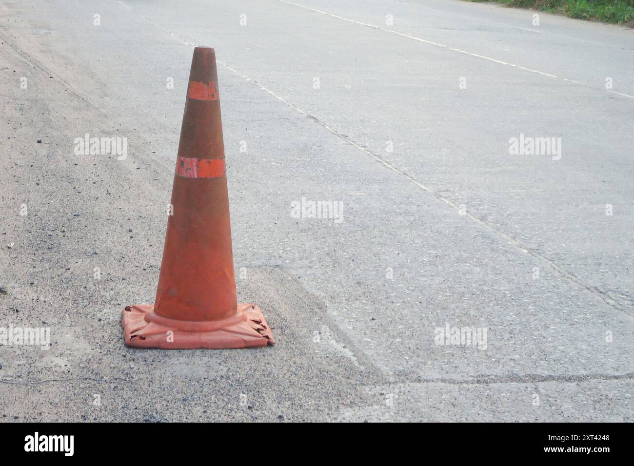 Old-fashioned orange traffic cones stand tall on the road Stock Photo ...