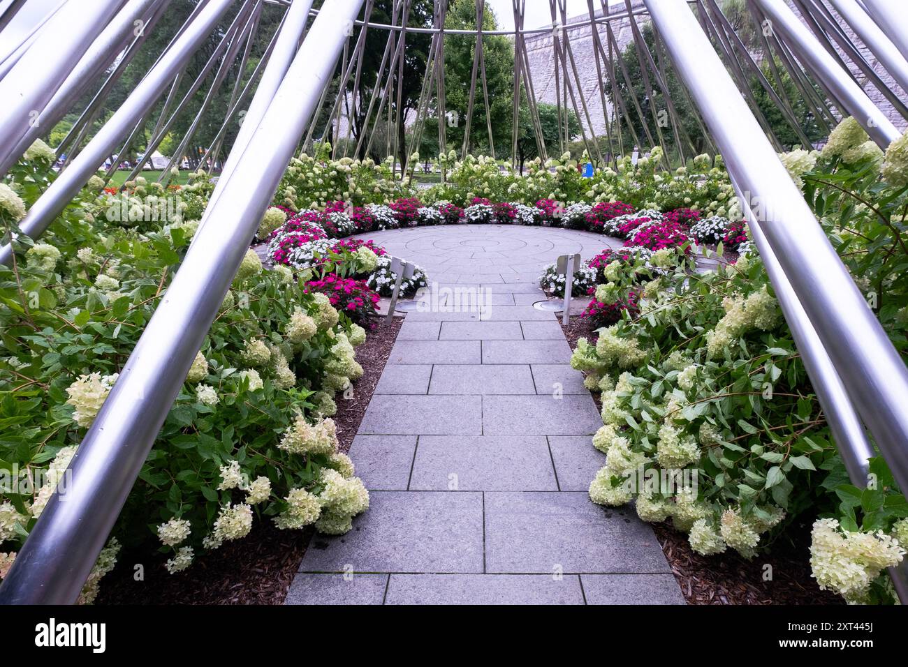 Ornate flowers arranged at the base of The Rise, a statue in Kensico ...
