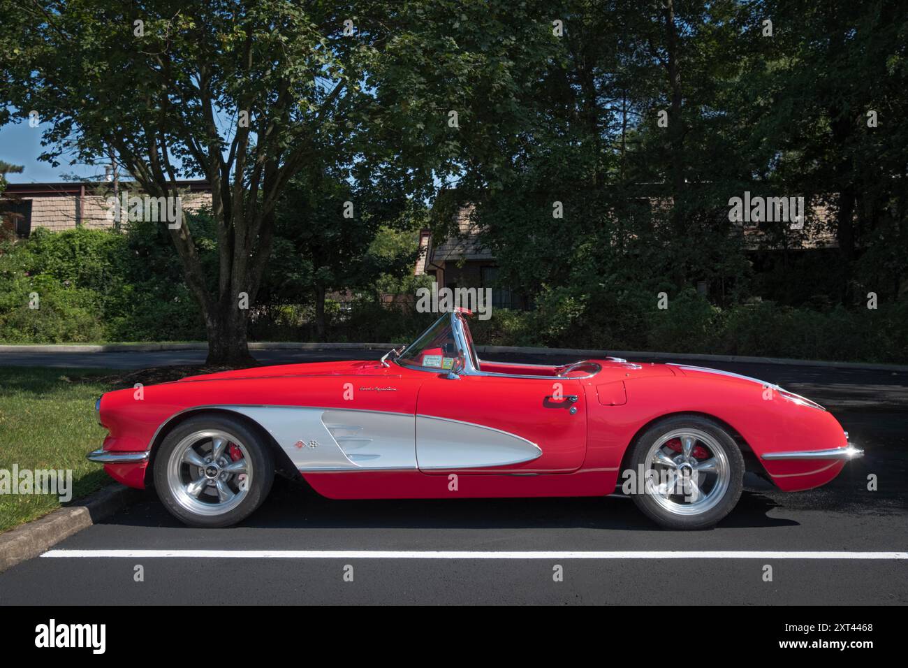 A restored red 1958 Corvette Sting Ray convertible parked red white in ...