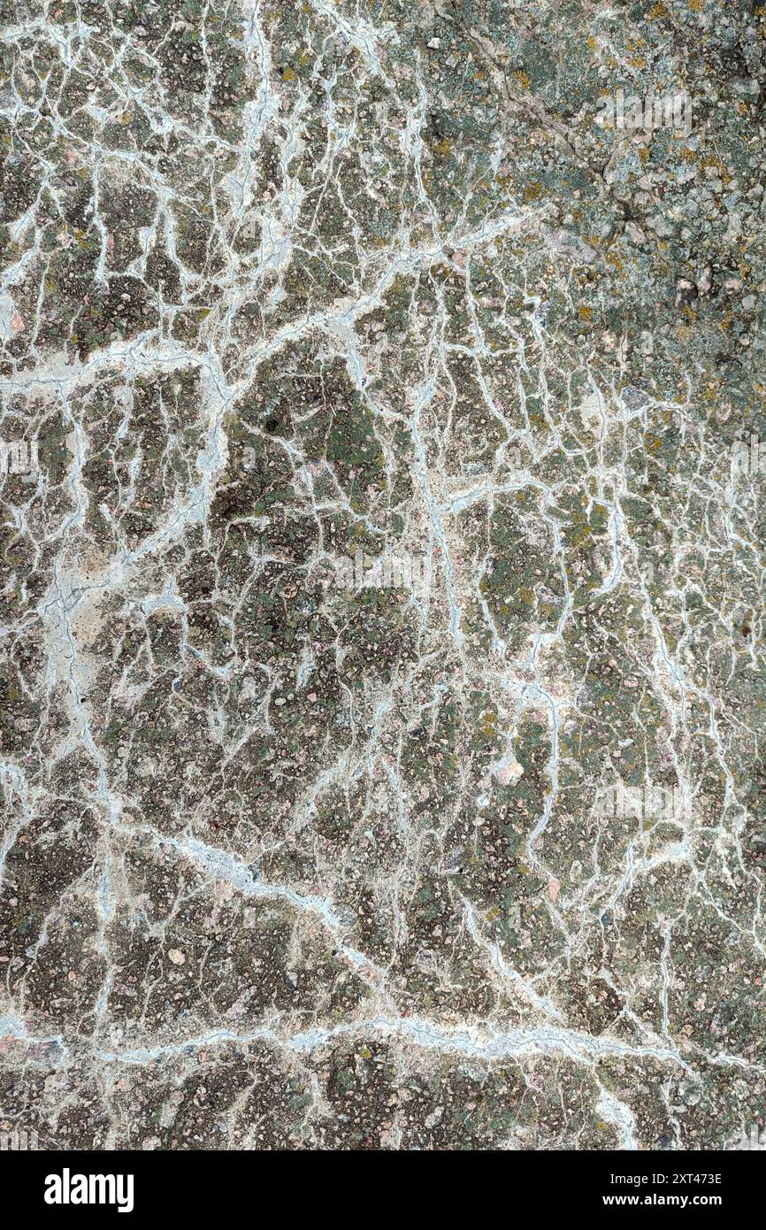 Concrete texture. Pebbles of different colors and signs of aging are ...