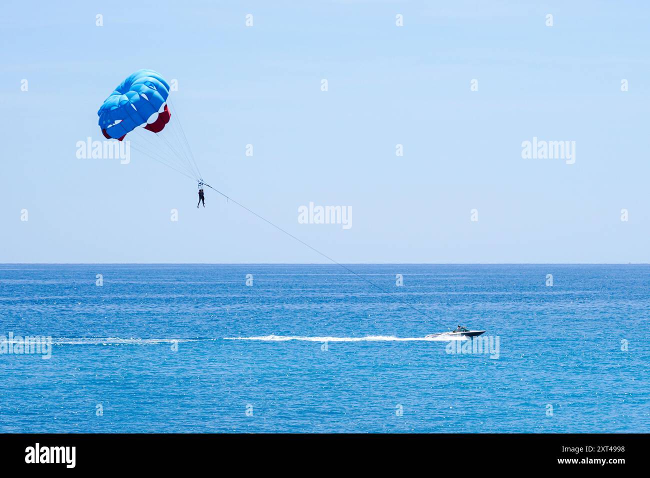 Idyllic parasailing view in the clear blue sea, the ultimate vacation ...