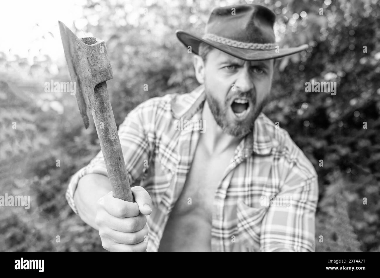 selective focus of angry lumberjack with axe. angry lumberjack with axe ...