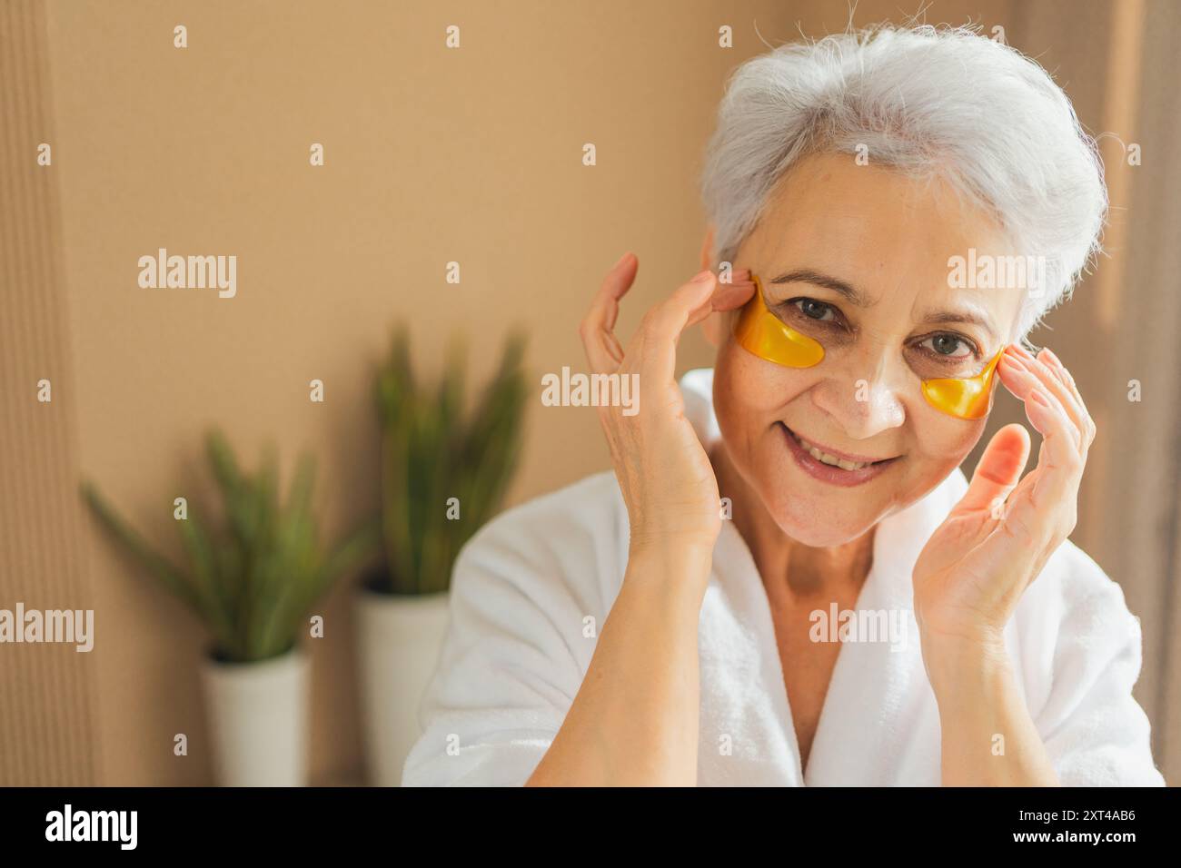 Eye patch beauty aging treatment. Mature adult old woman with under eye ...