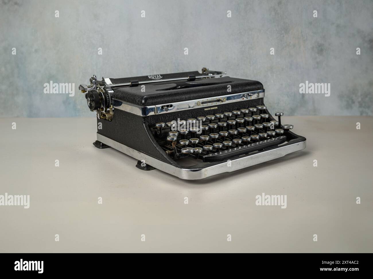 1930s vintage portable manual typewriter on beige table with blue ...