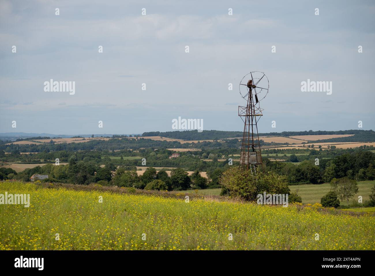 An old wind water pump in a Warwickshire summer landscape, England, UK ...