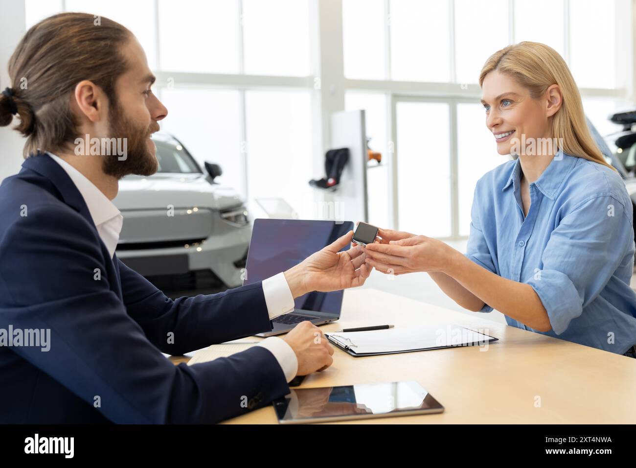 Rich woman customer client signing contract with salesman in car ...