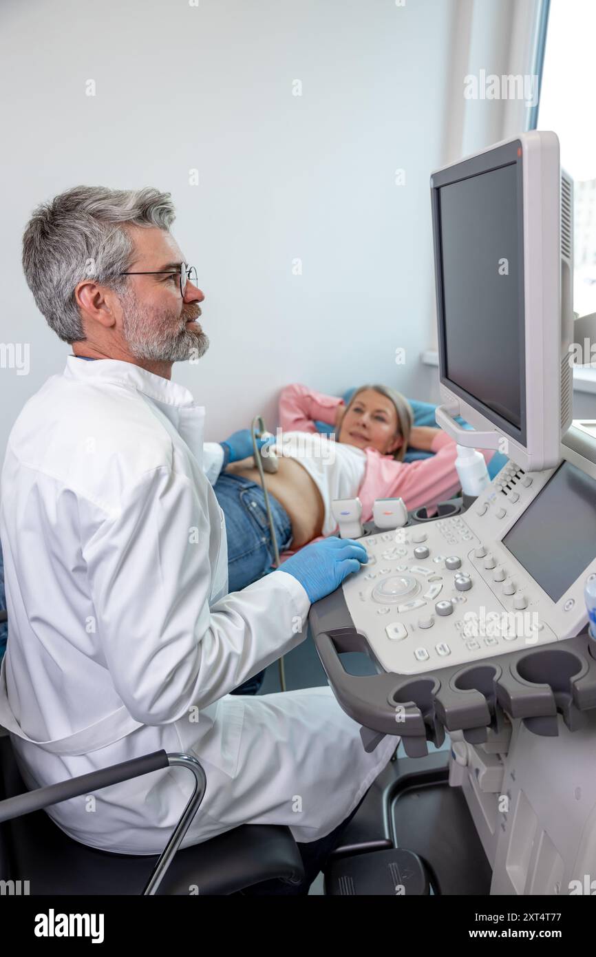 Male doctor looking focused while making diagnostics to a female ...