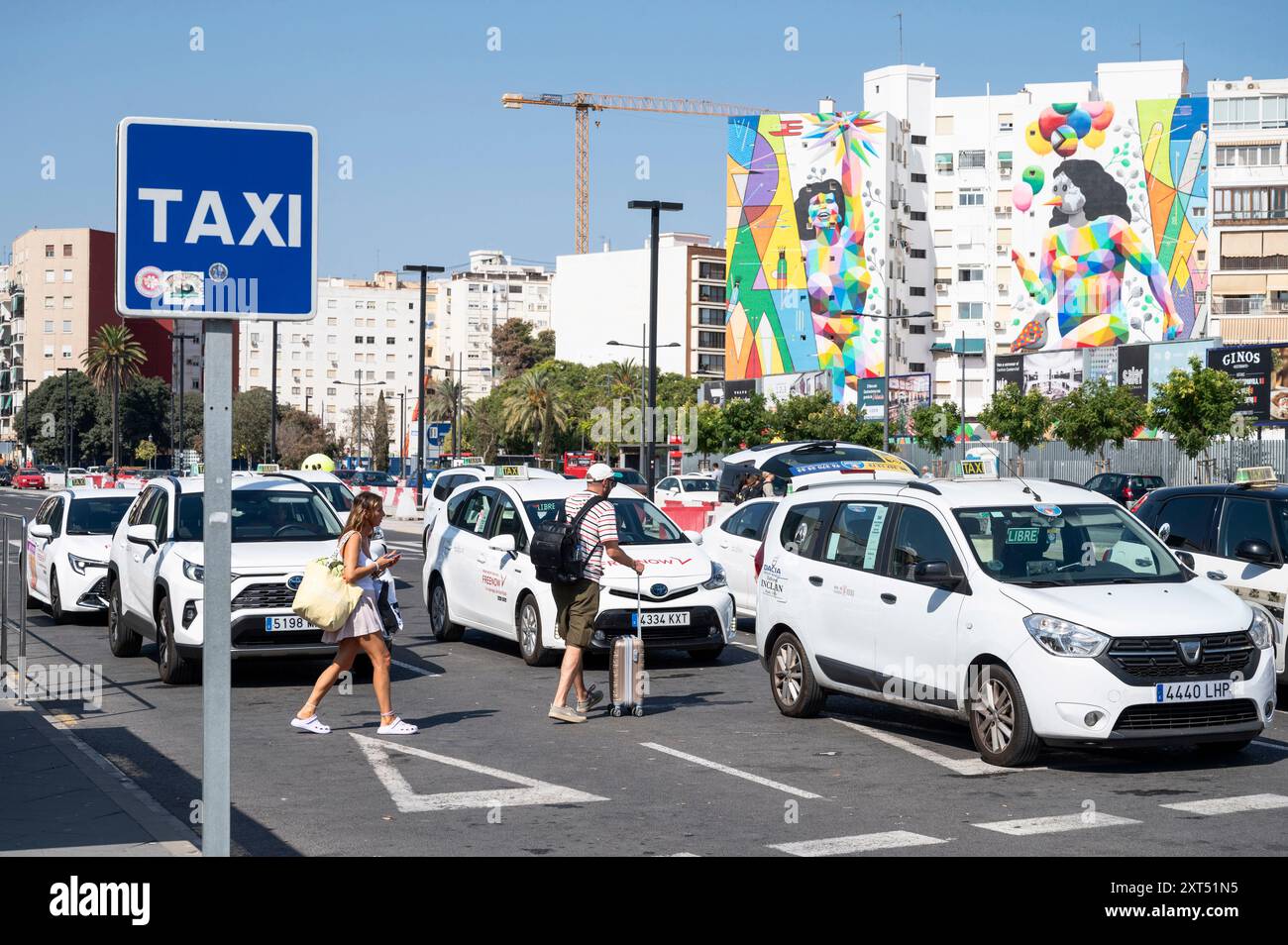 Tourists seen crossing the road to board taxis at the taxi queue ...