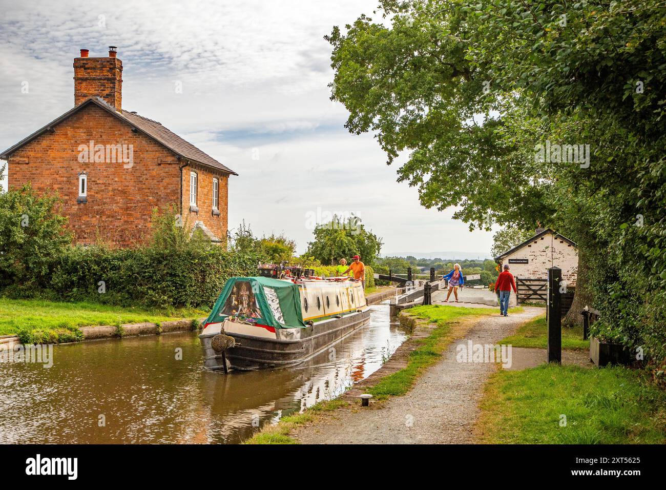 People on canal narrowboats, passing through Hurleston top locks on the ...