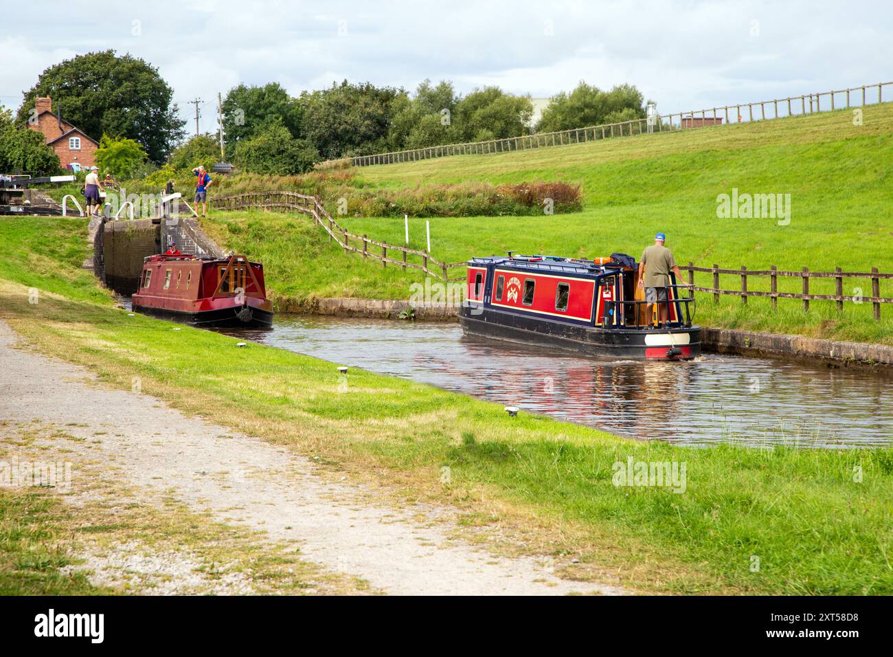 People on a canal narrowboat passing through Hurleston locks on the ...