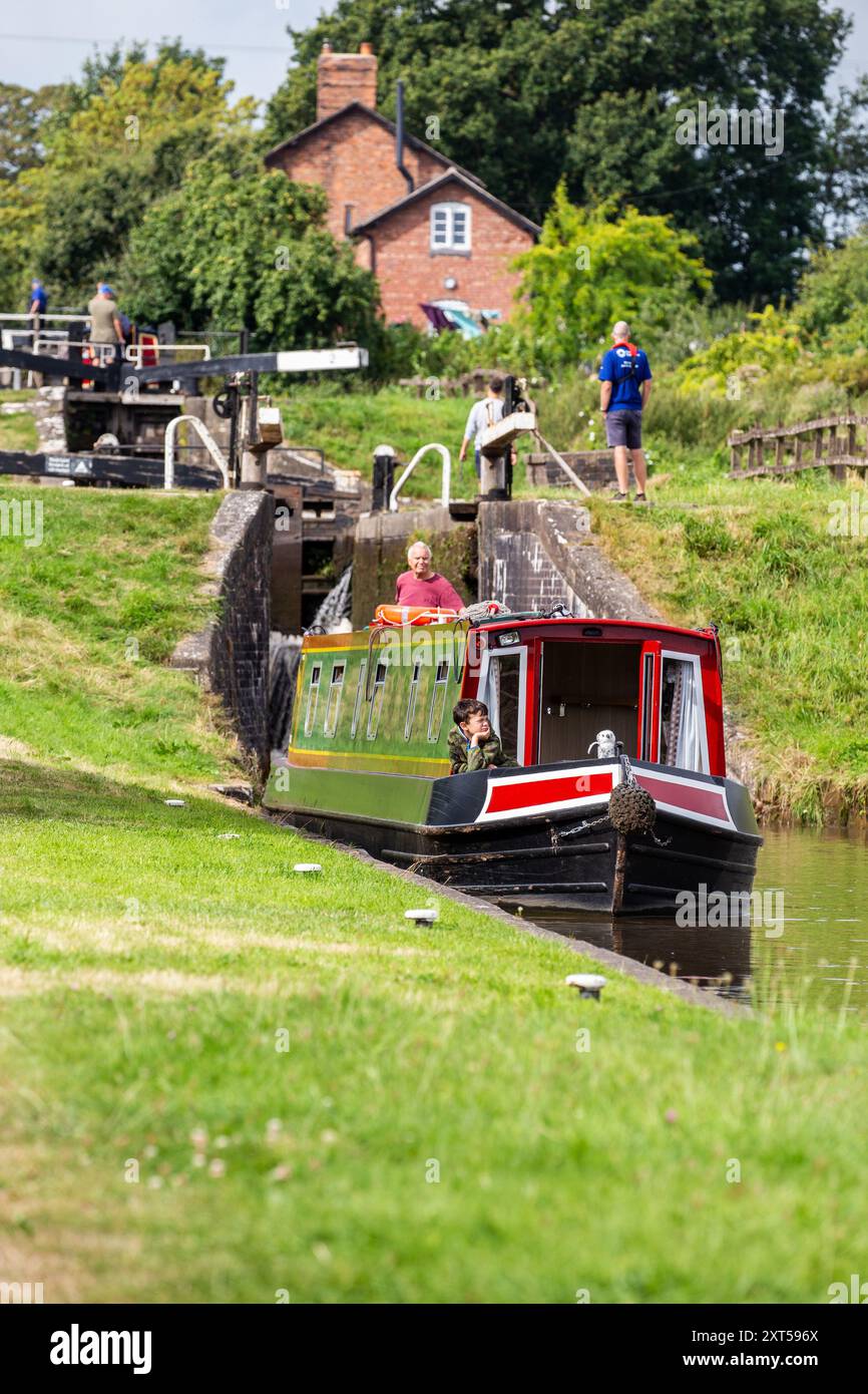 People on canal narrowboat passing through Hurleston locks on the ...