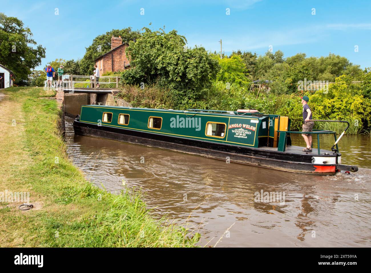 People on canal narrowboats, passing through Hurleston top locks on the ...
