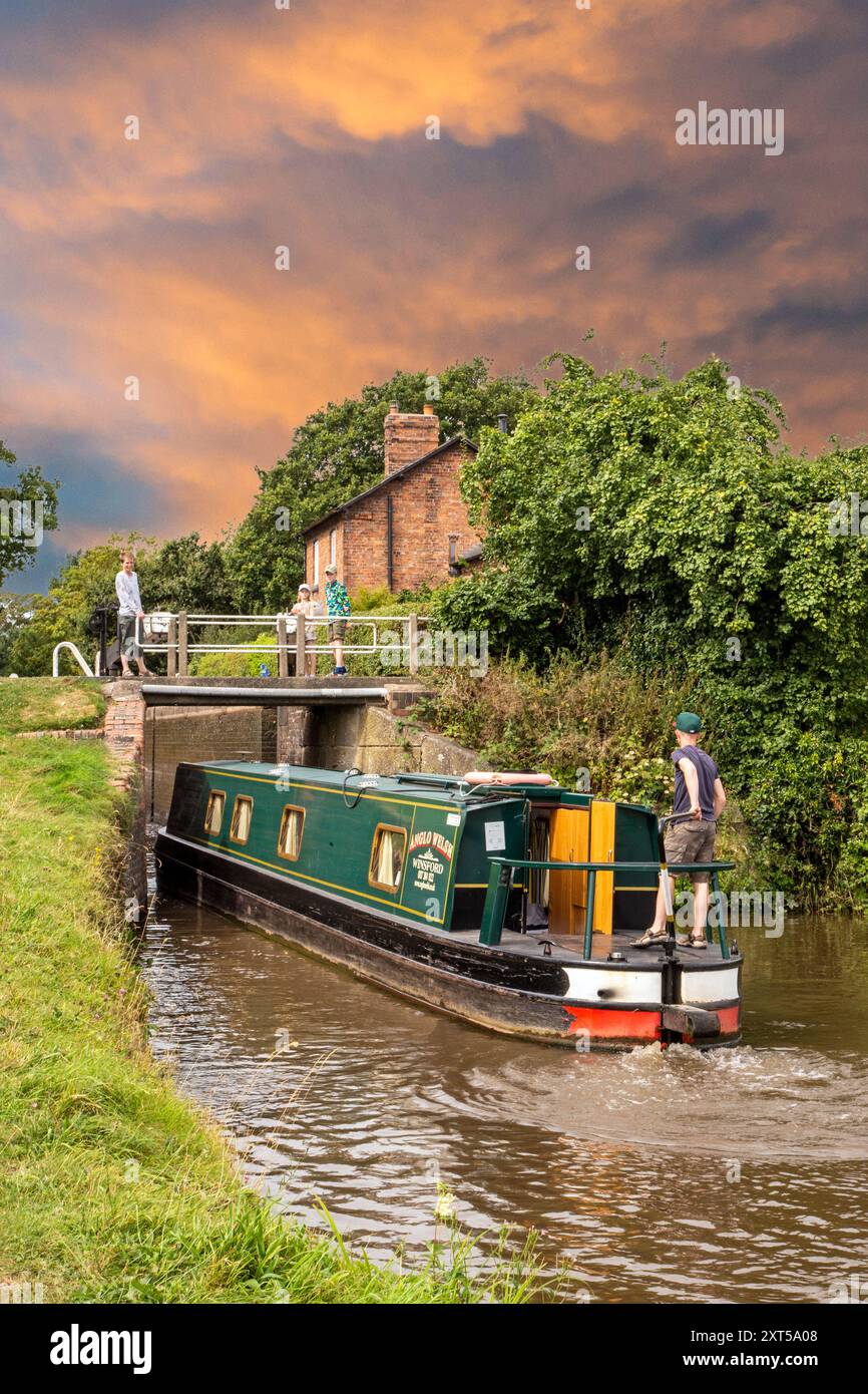 People on canal narrowboats, passing through Hurleston top locks on the ...