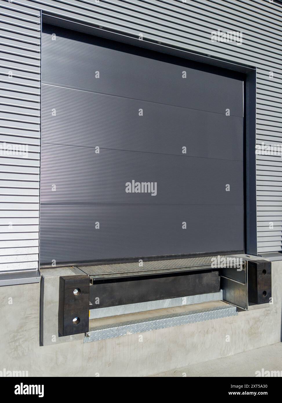 Closed industrial loading dock door with metallic exterior Stock Photo ...