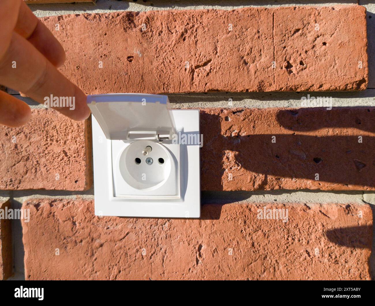 Hand Opening Outdoor Electrical Outlet Cover Stock Photo - Alamy